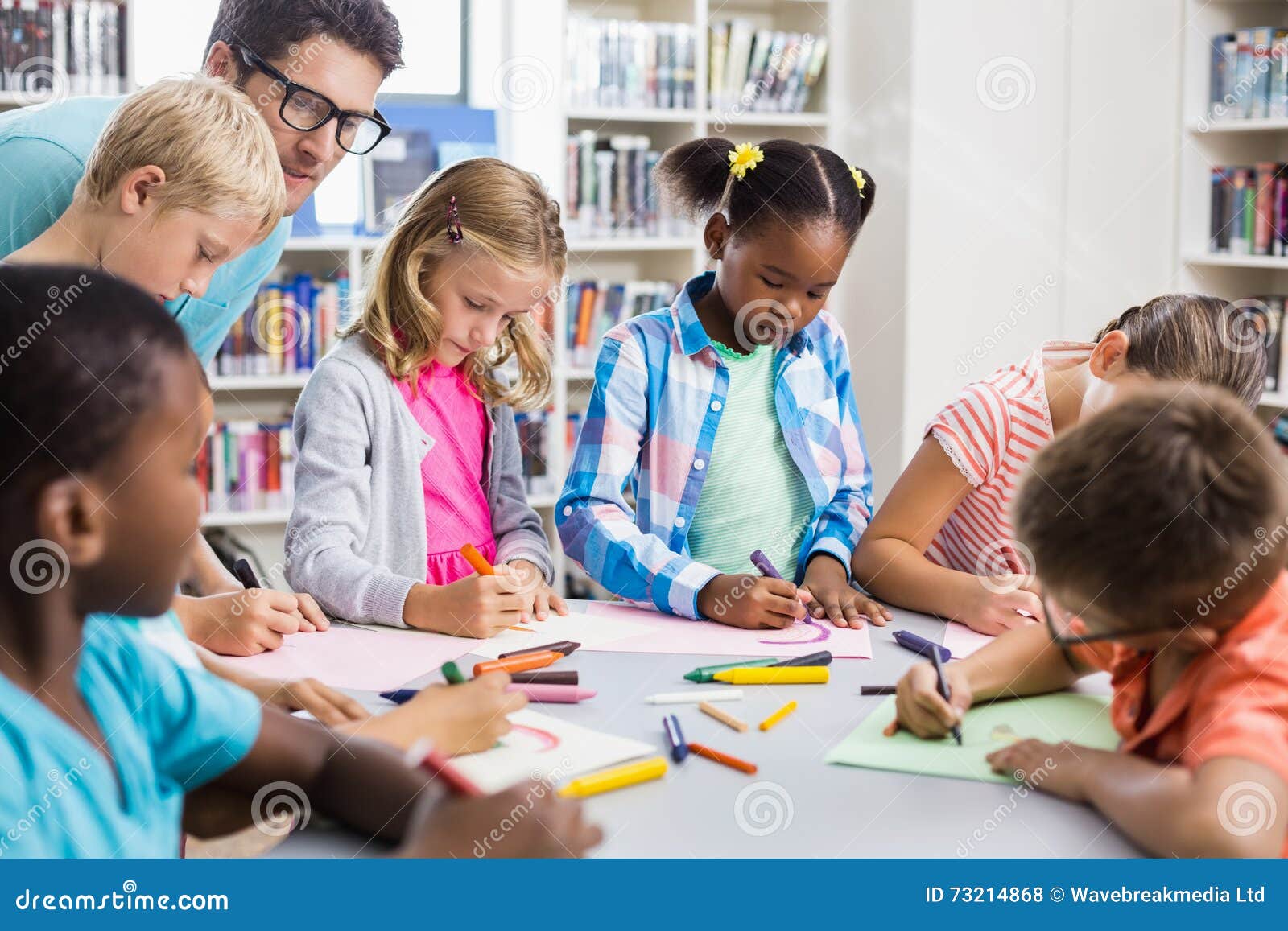 Teacher Helping Kids with Their Homework in Library Stock Photo - Image ...