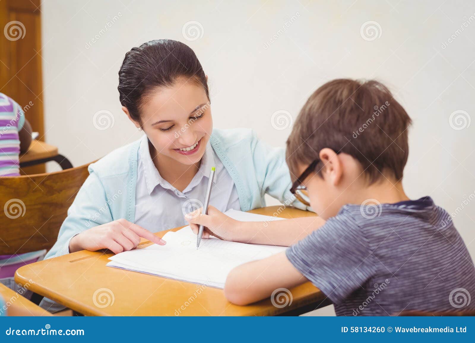 Teacher Helping a Little Boy during Class Stock Photo - Image of female ...