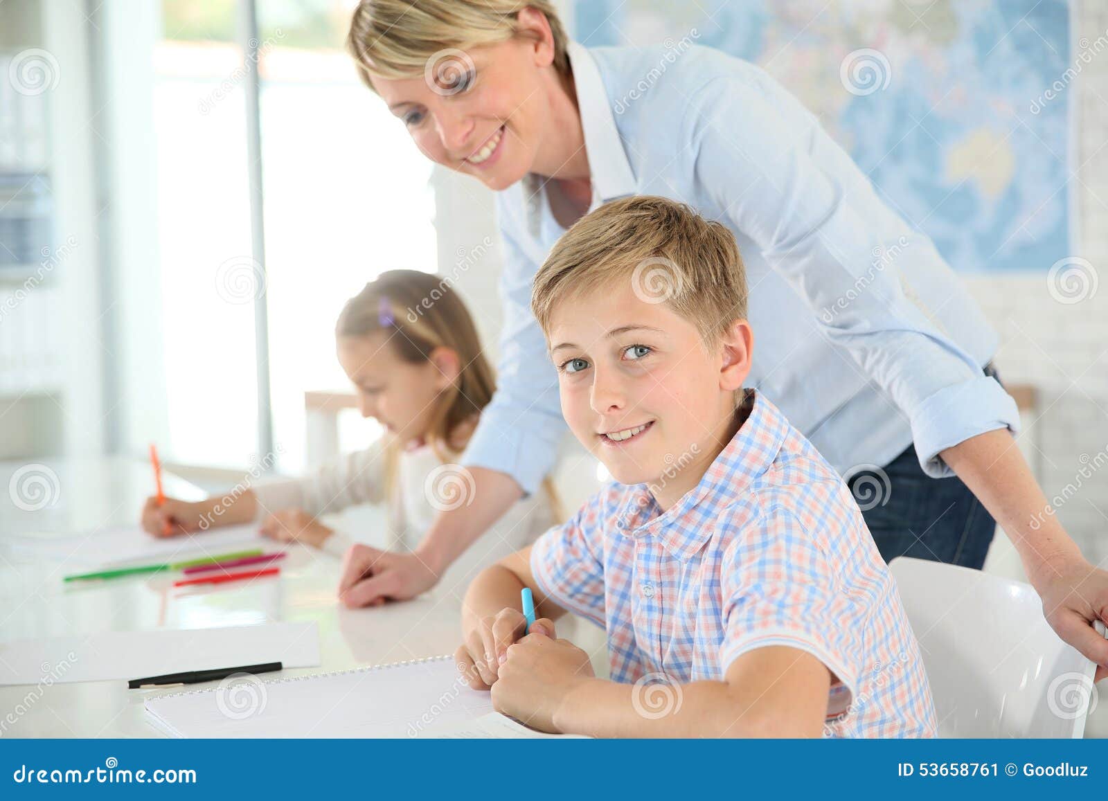 Teacher Helping Pupils in Class Stock Image - Image of student, girl ...