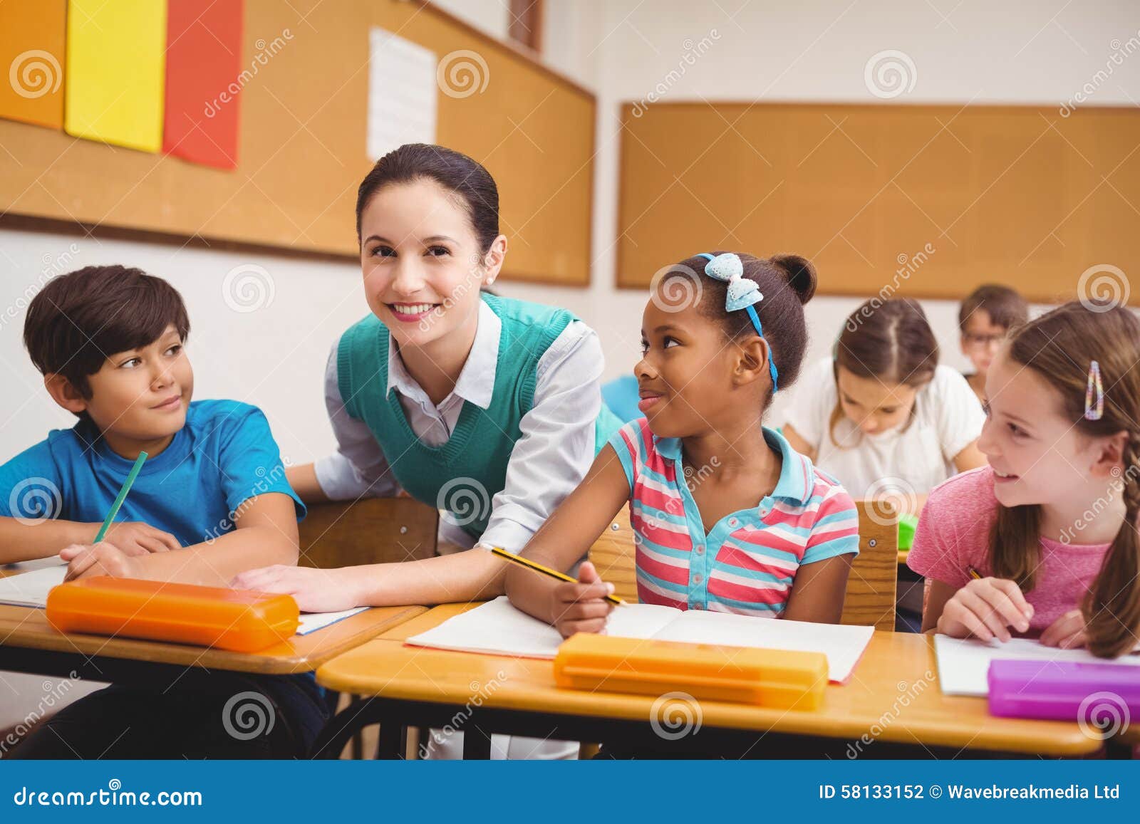 Teacher Helping Pupils during Class Stock Photo - Image of classroom ...