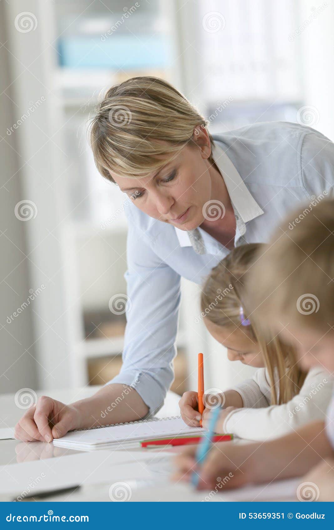 Teacher Helping Pupils in Classroom Stock Image - Image of education ...
