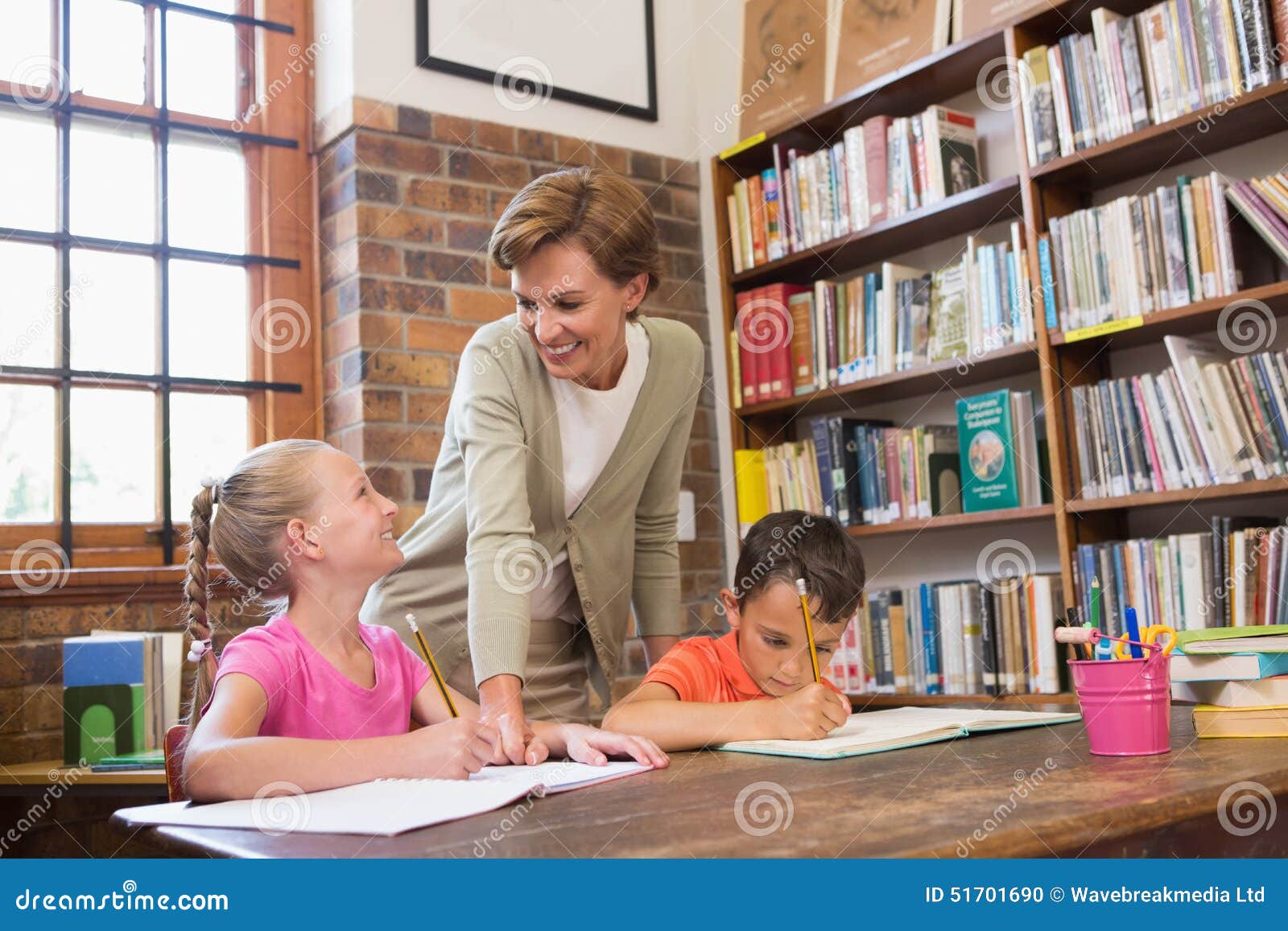 Teacher Helping Pupils in Library Stock Photo - Image of learning ...