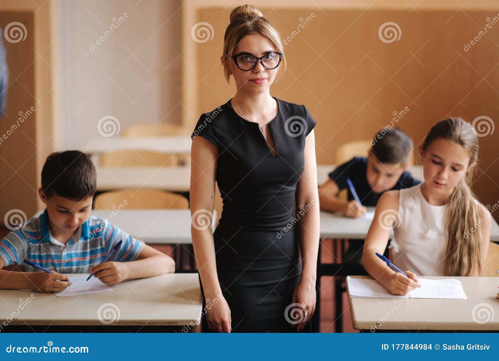 Teacher Helping School Kids Writing Test in Classroom. Education ...