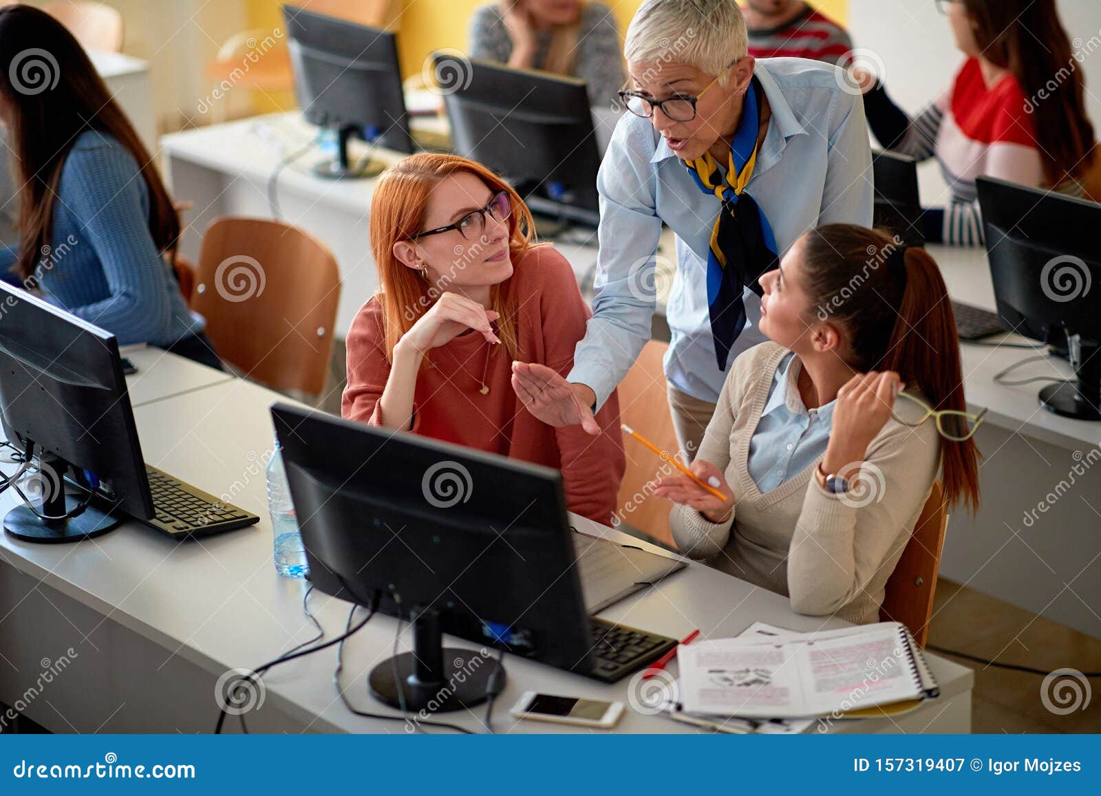 Teacher Helping Students on Project Stock Image - Image of multi ...
