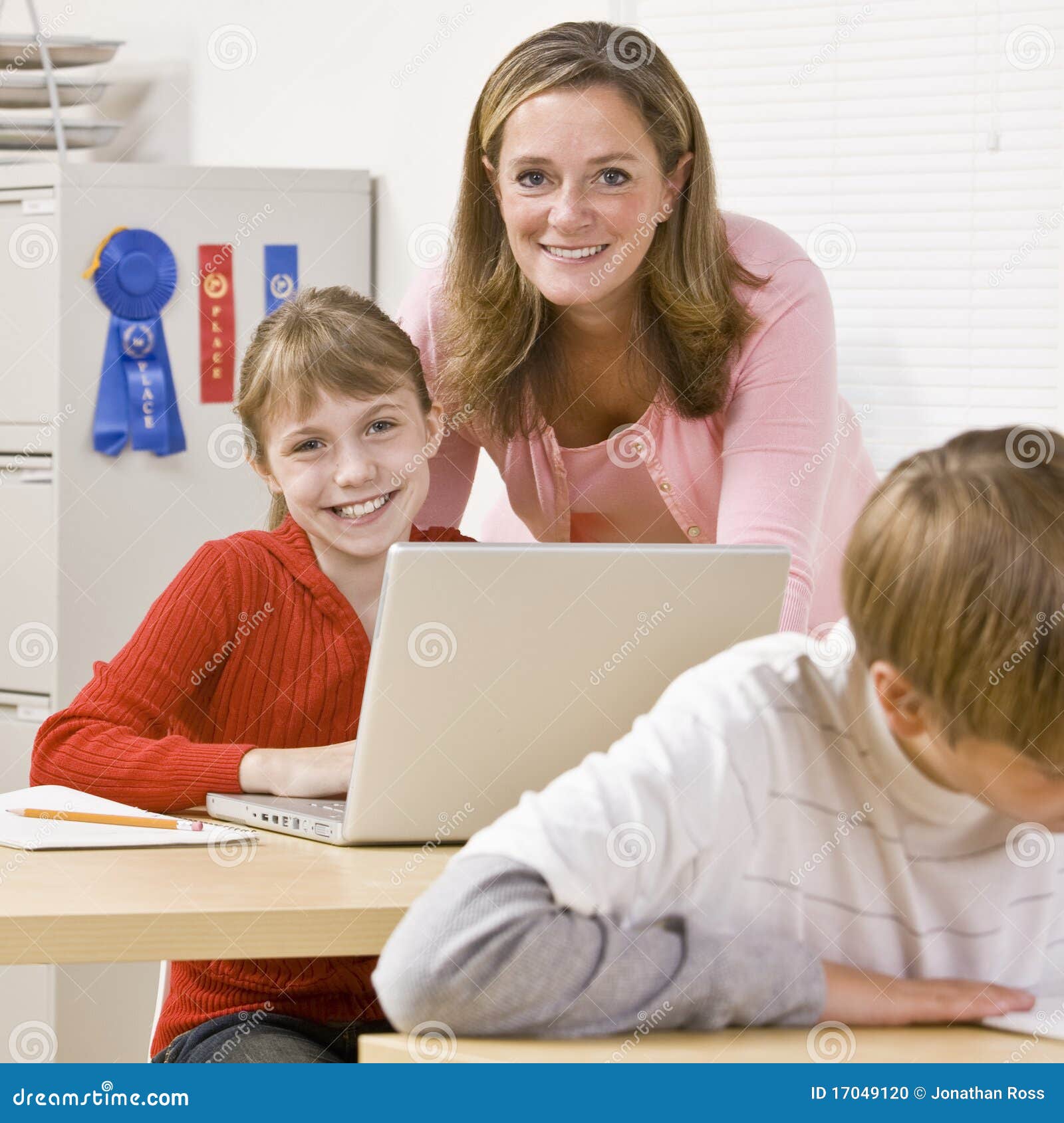 Teacher helping student stock photo. Image of classroom - 17049120