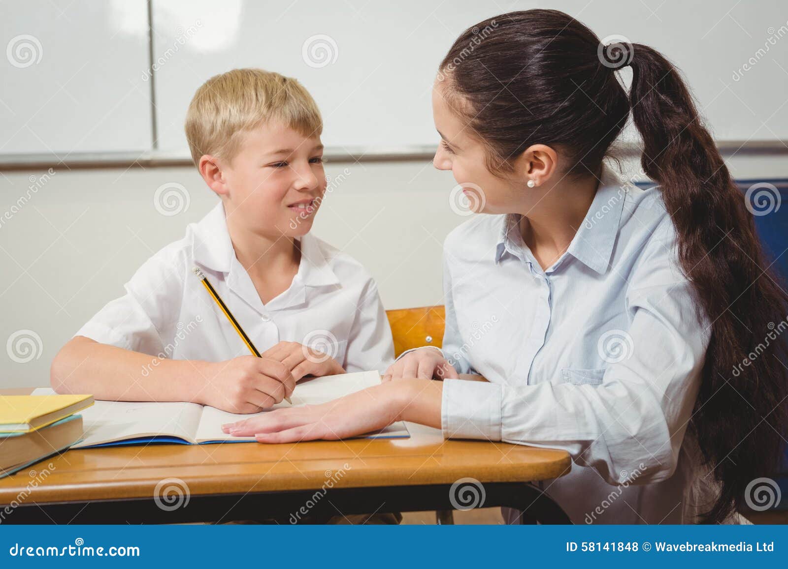 Teacher Helping a Student in Class Stock Photo - Image of smiling ...