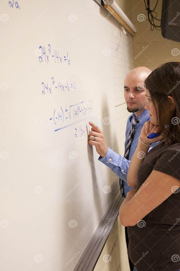 Teacher Helping Student with a Math Problem on a Whiteboard. Stock ...