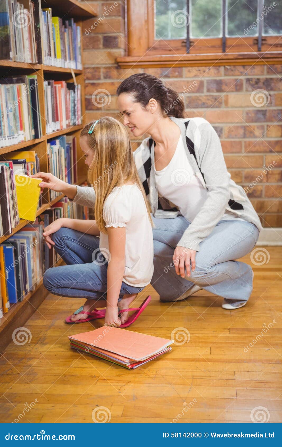Teacher Helping a Student Pick a Book Stock Photo - Image of occupation ...
