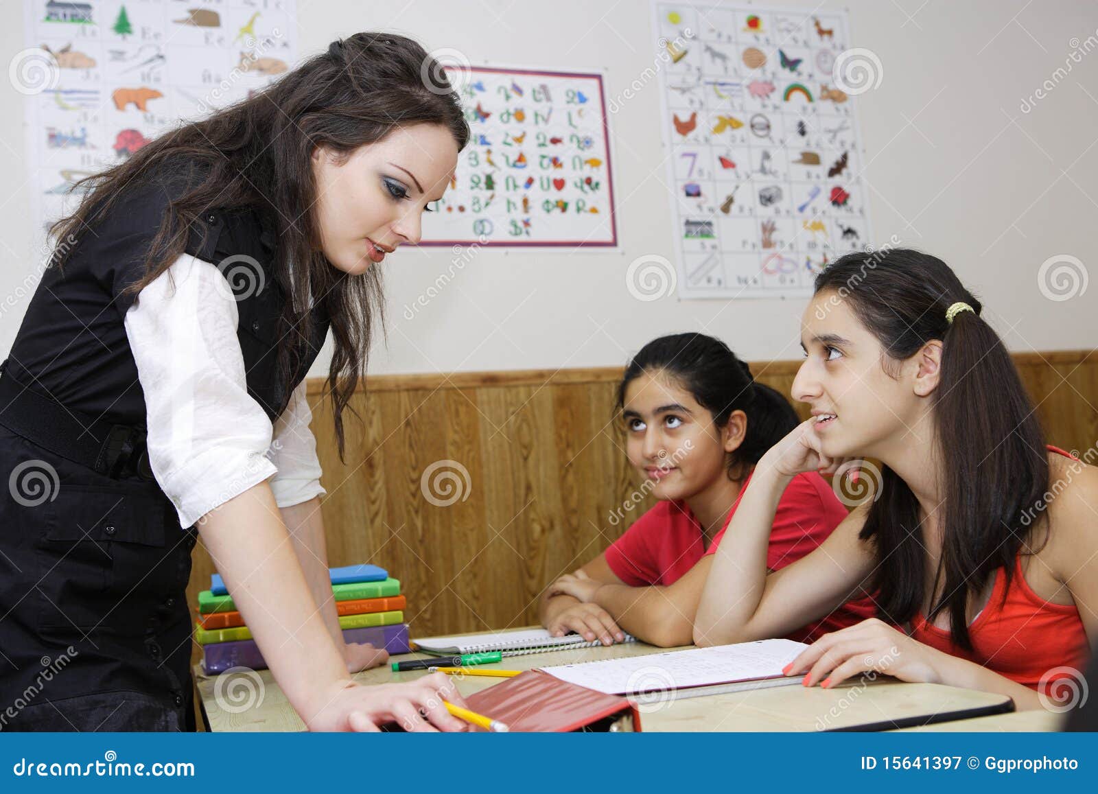 Teacher helping students stock image. Image of foreign - 15641397