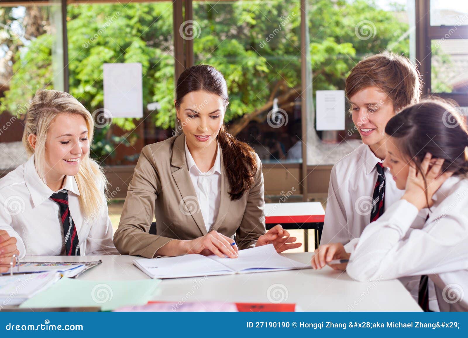 Teacher helping students stock photo. Image of classmates - 27190190