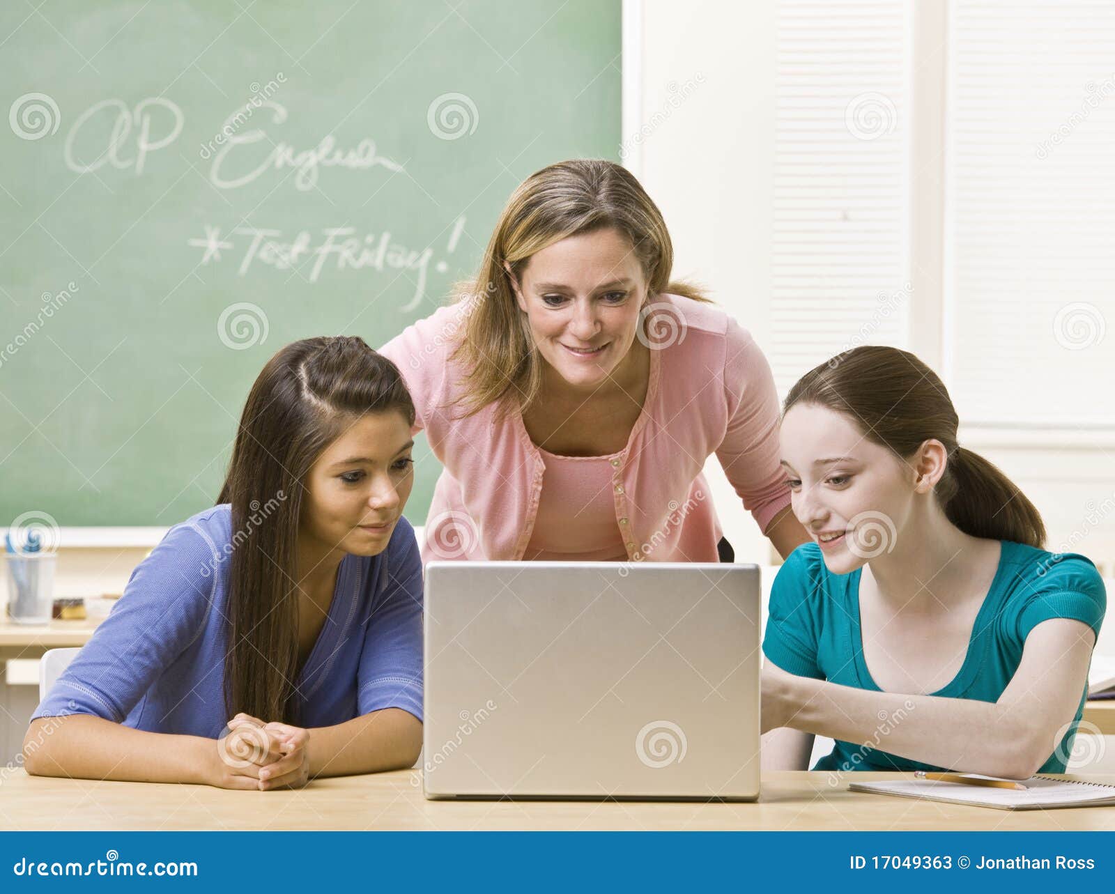 Teacher Helping Students on Laptop Stock Image - Image of people ...