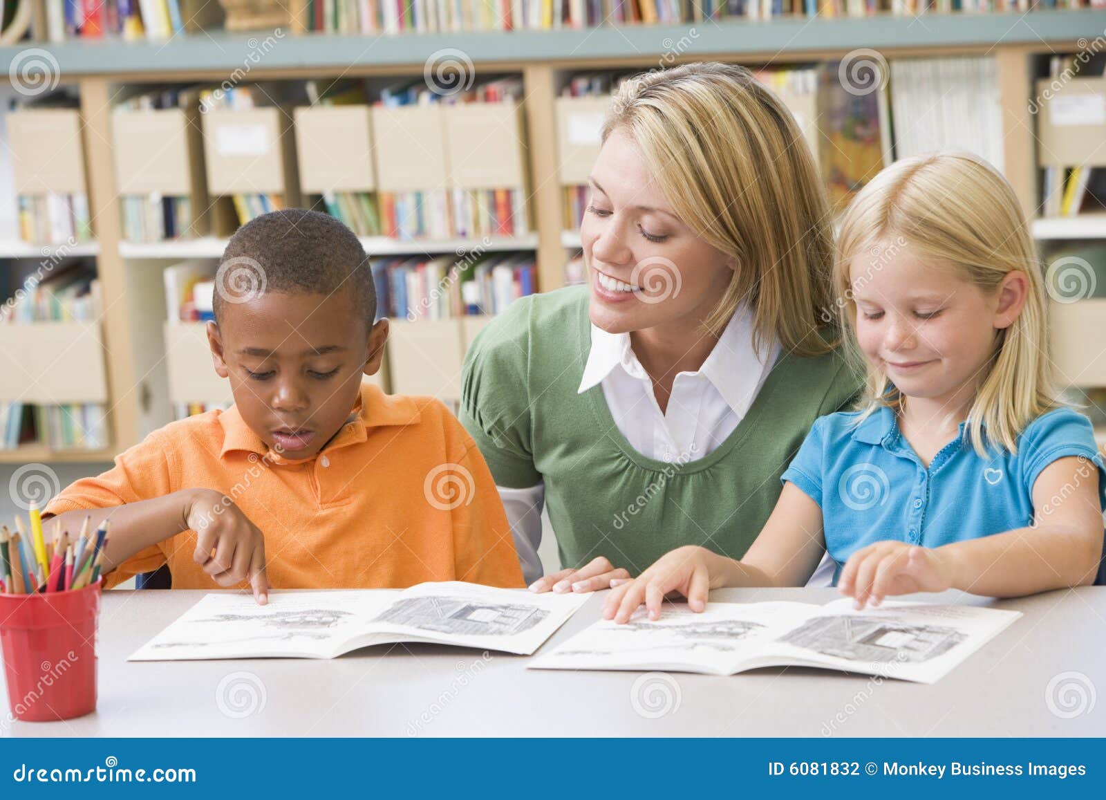 Teacher Helping Students with Reading Skills Stock Photo - Image of ...