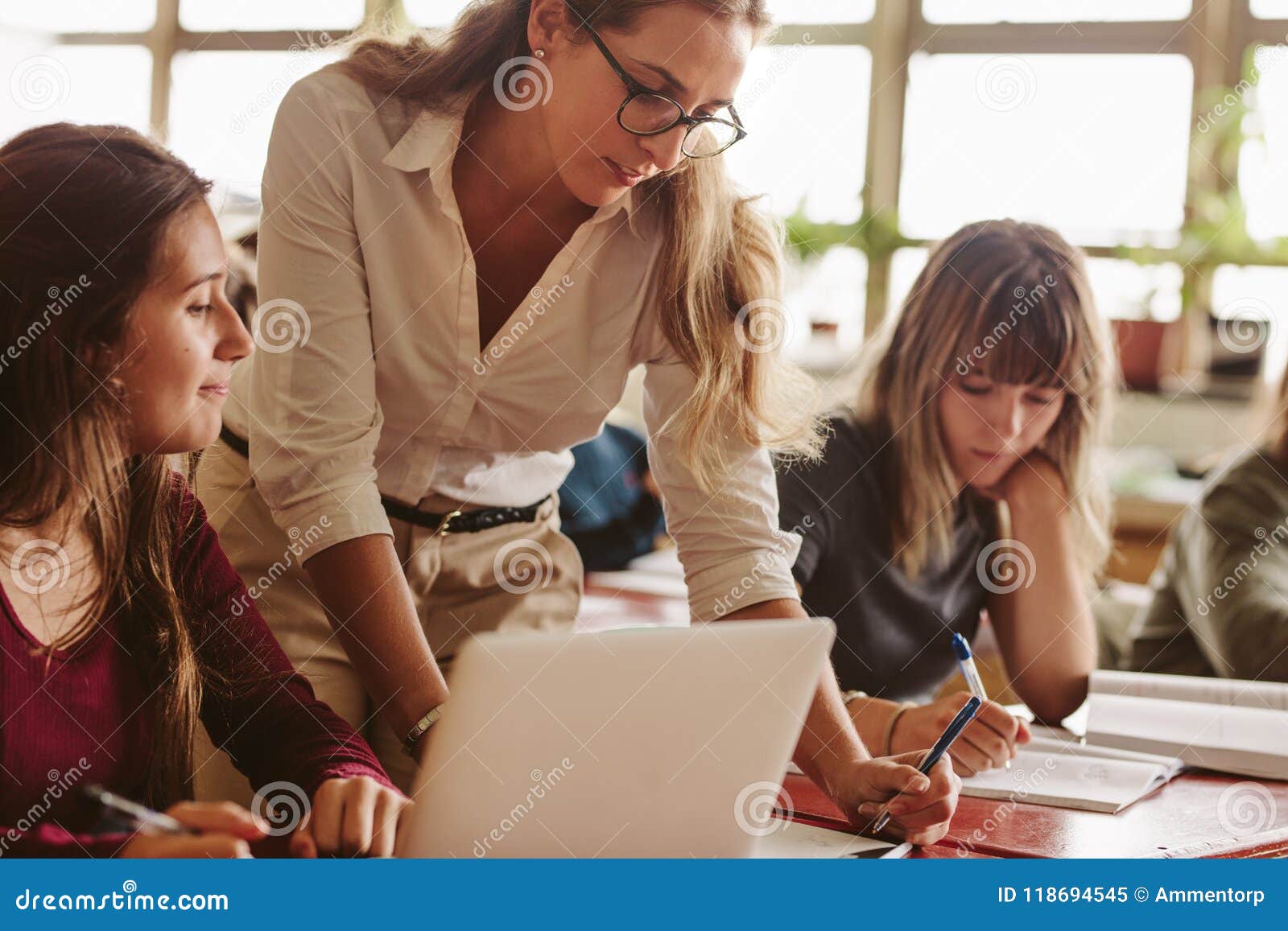 Teacher Helping Students Study Stock Image - Image of student, learning ...