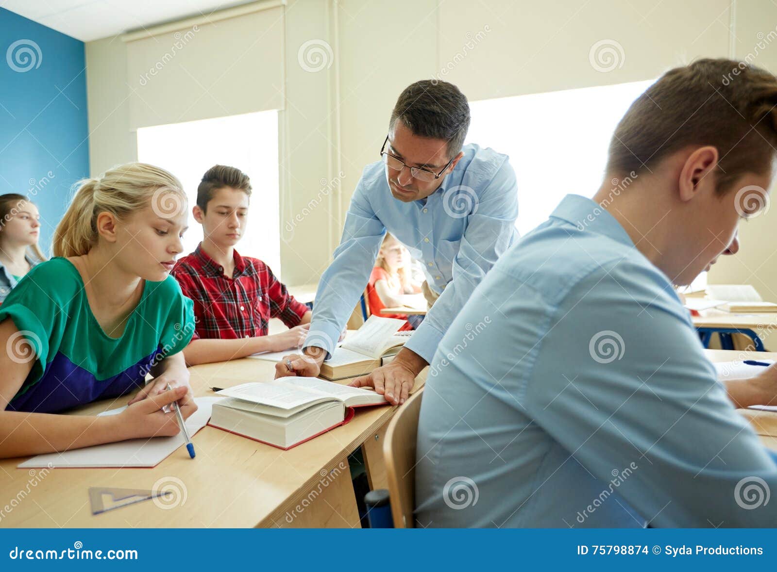 Teacher Helping Students with Task at School Stock Photo - Image of ...