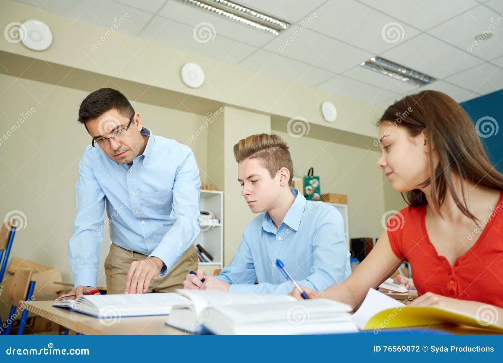 Teacher Helping Students with Task at School Stock Photo - Image of ...