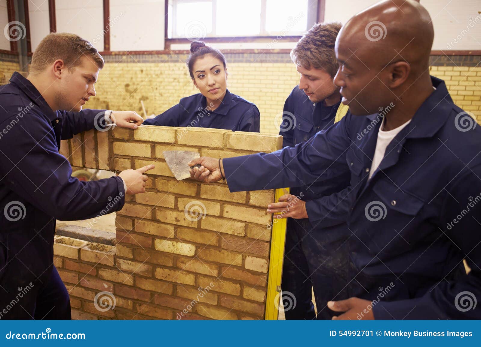 Teacher Helping Students Training To Be Builders Stock Image - Image of ...