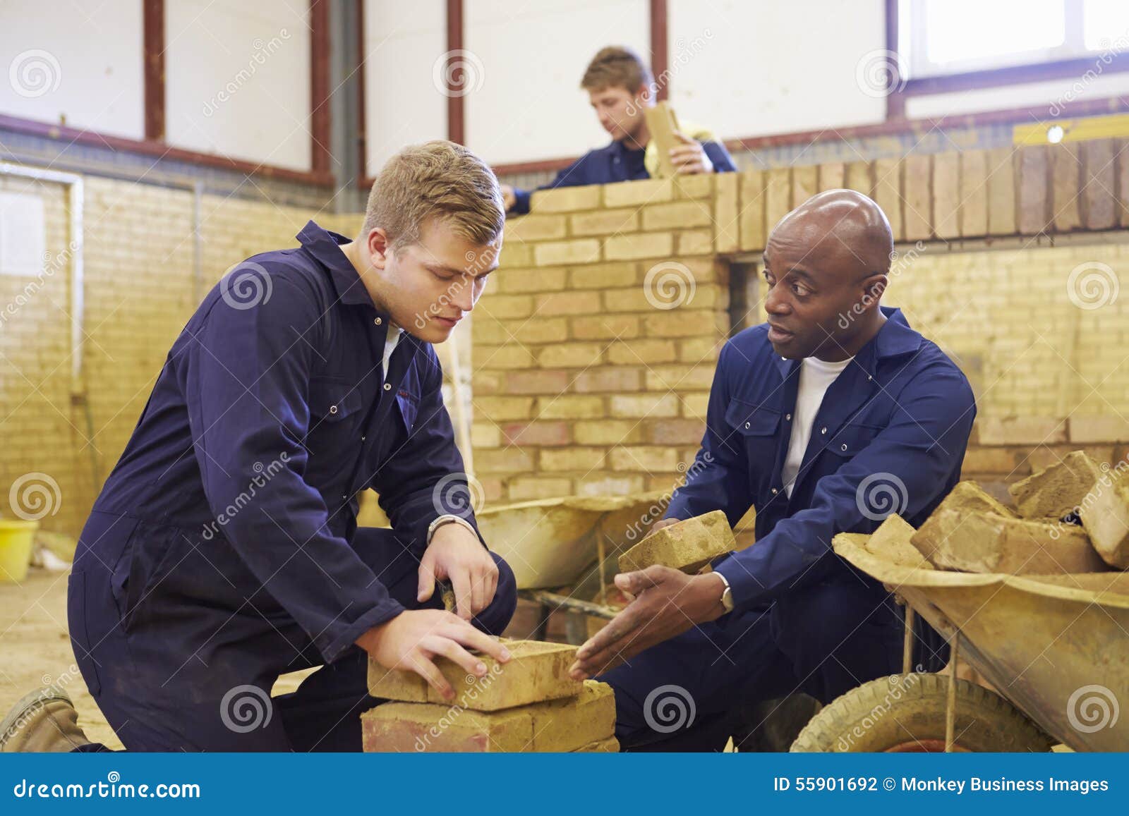 Teacher Helping Students Training To Be Builders Stock Photo - Image of ...