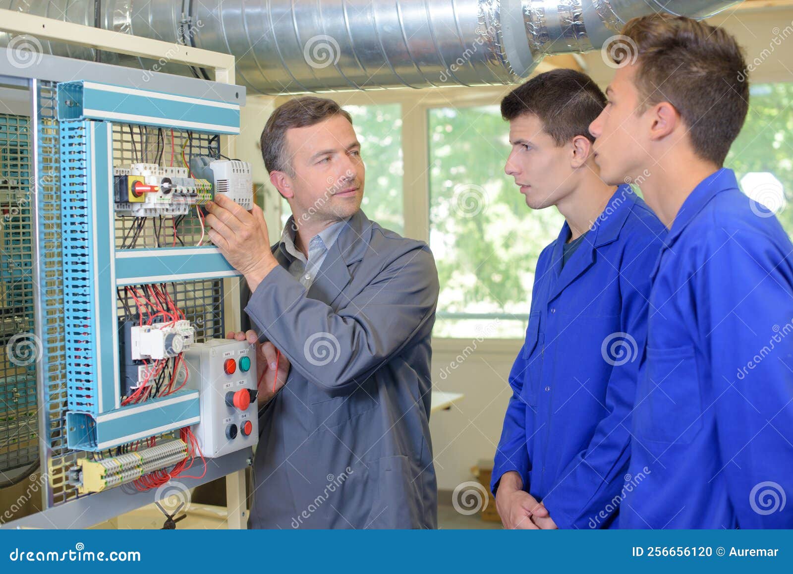 Teacher Helping Students Training To Be Electricians Stock Photo ...