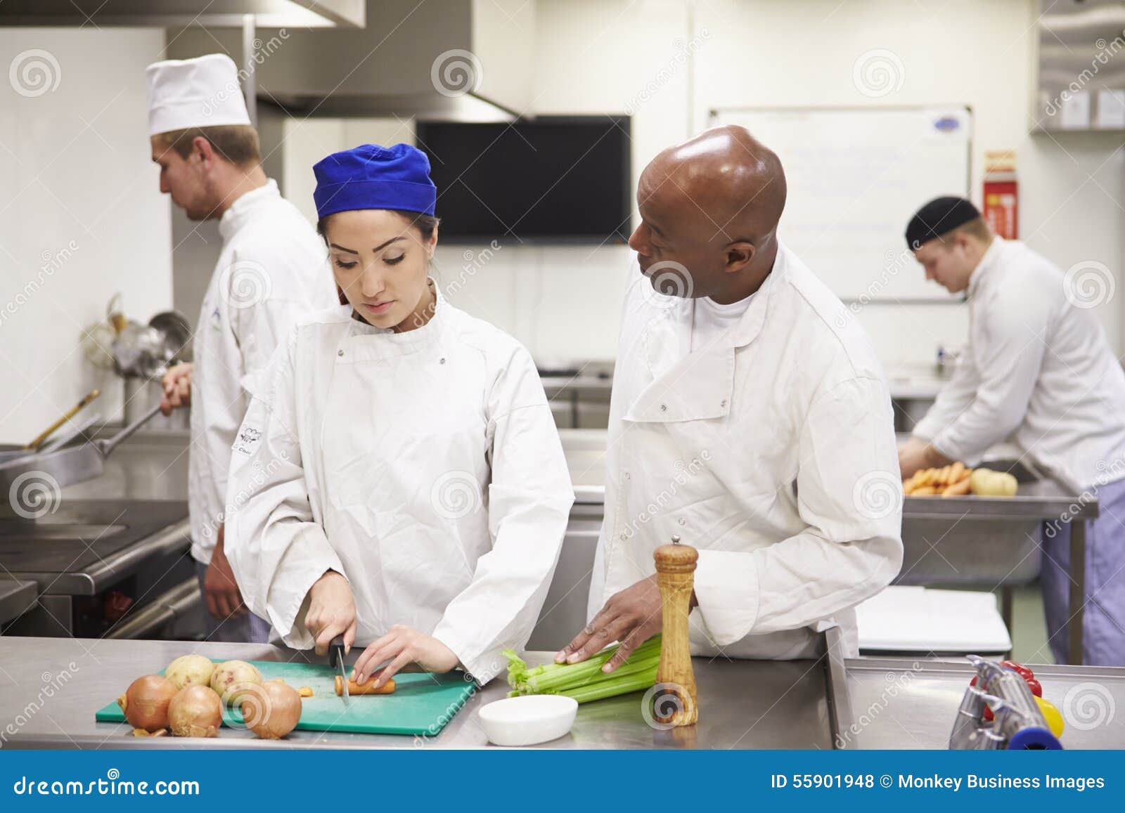 Teacher Helping Students Training To Work in Catering Stock Photo ...