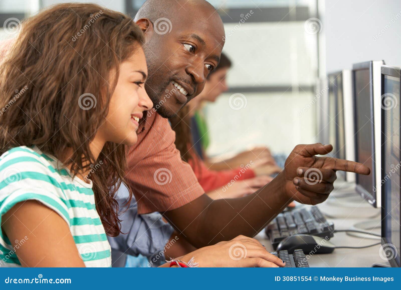 Teacher Helping Students Working at Computers in Classroom Stock Photo ... Teacher Helping Students Working at Computers in Classroom Stock Photo ...