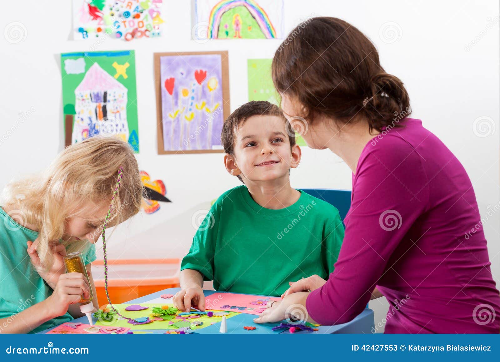 The Teacher Helps Schoolgirls In The Lesson, Prompting How To Solve The ... The Teacher Helps Schoolgirls In The Lesson, Prompting How To Solve The ...