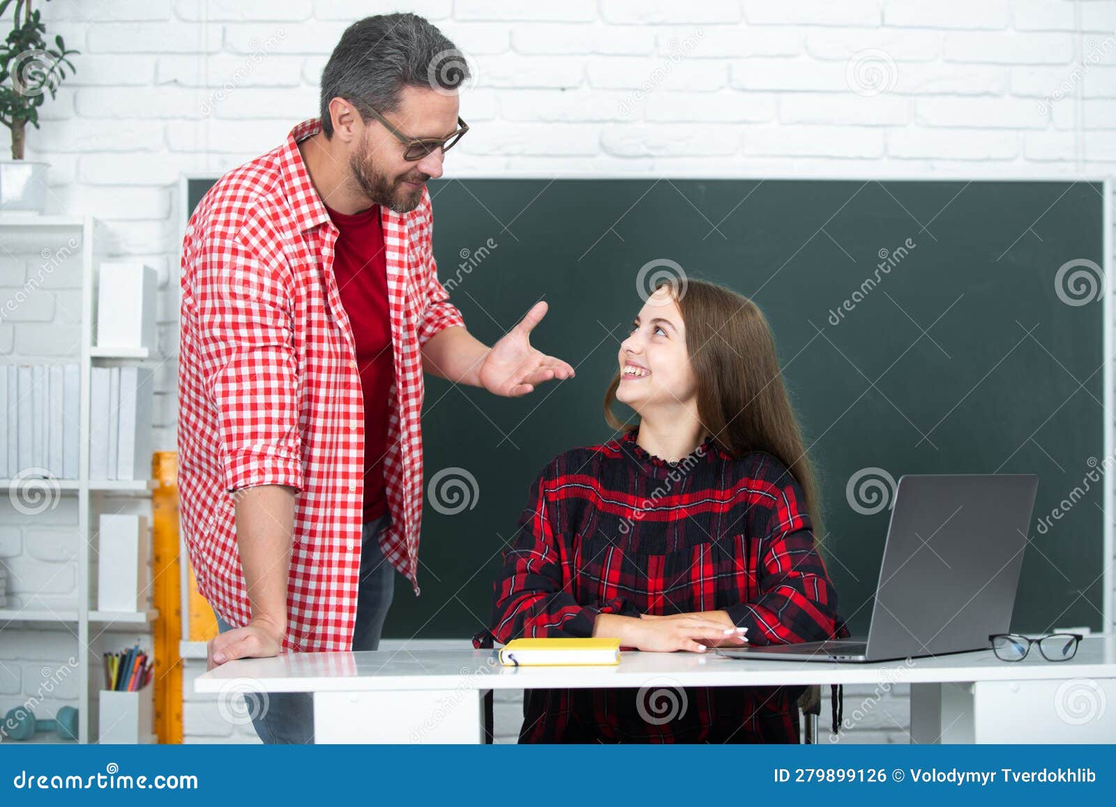 Teacher Helps School Kids To Learn Lesson. Stock Photo - Image of ...