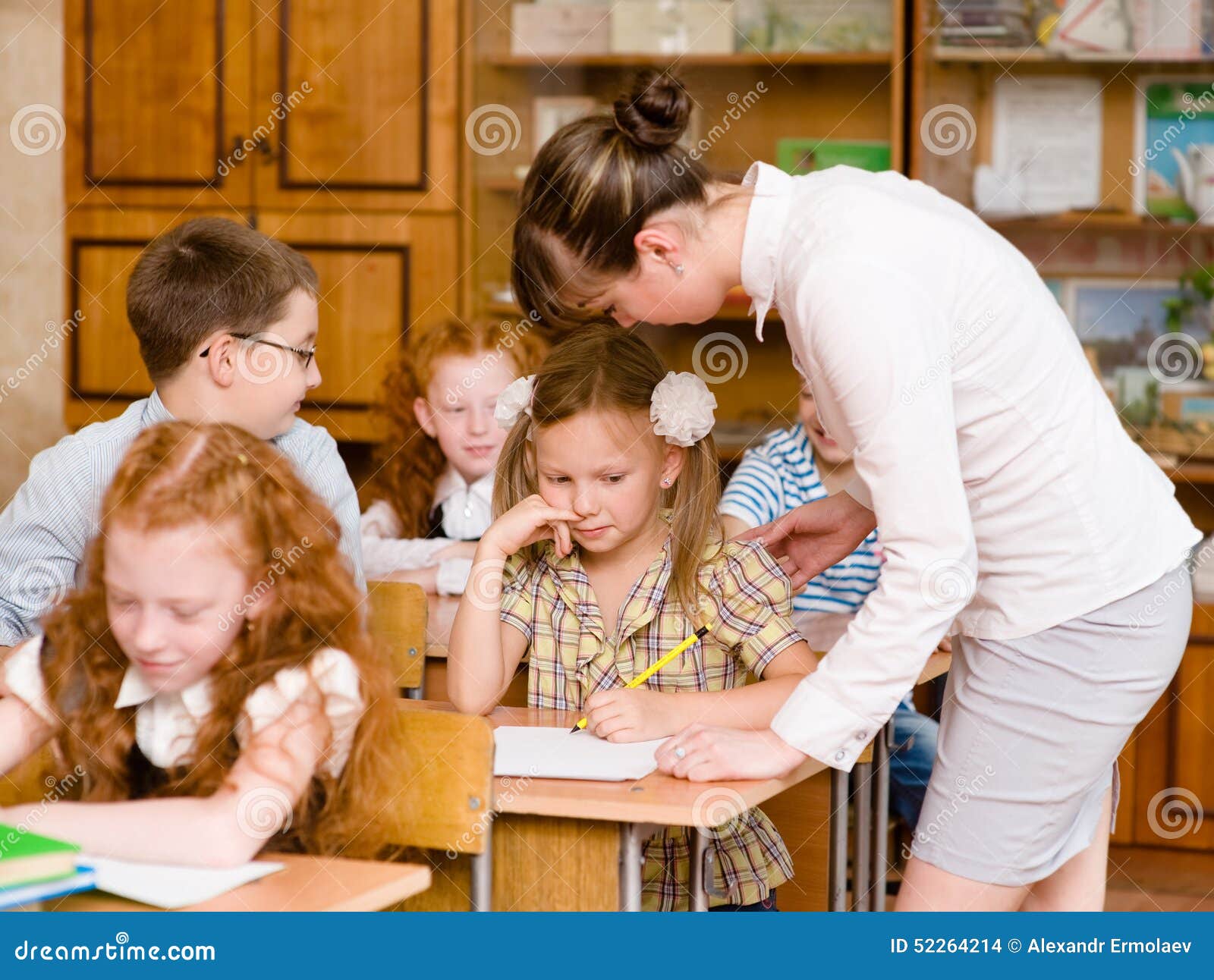 Teacher Helps the Schoolkids with Schoolwork in Classroom Stock Photo ...
