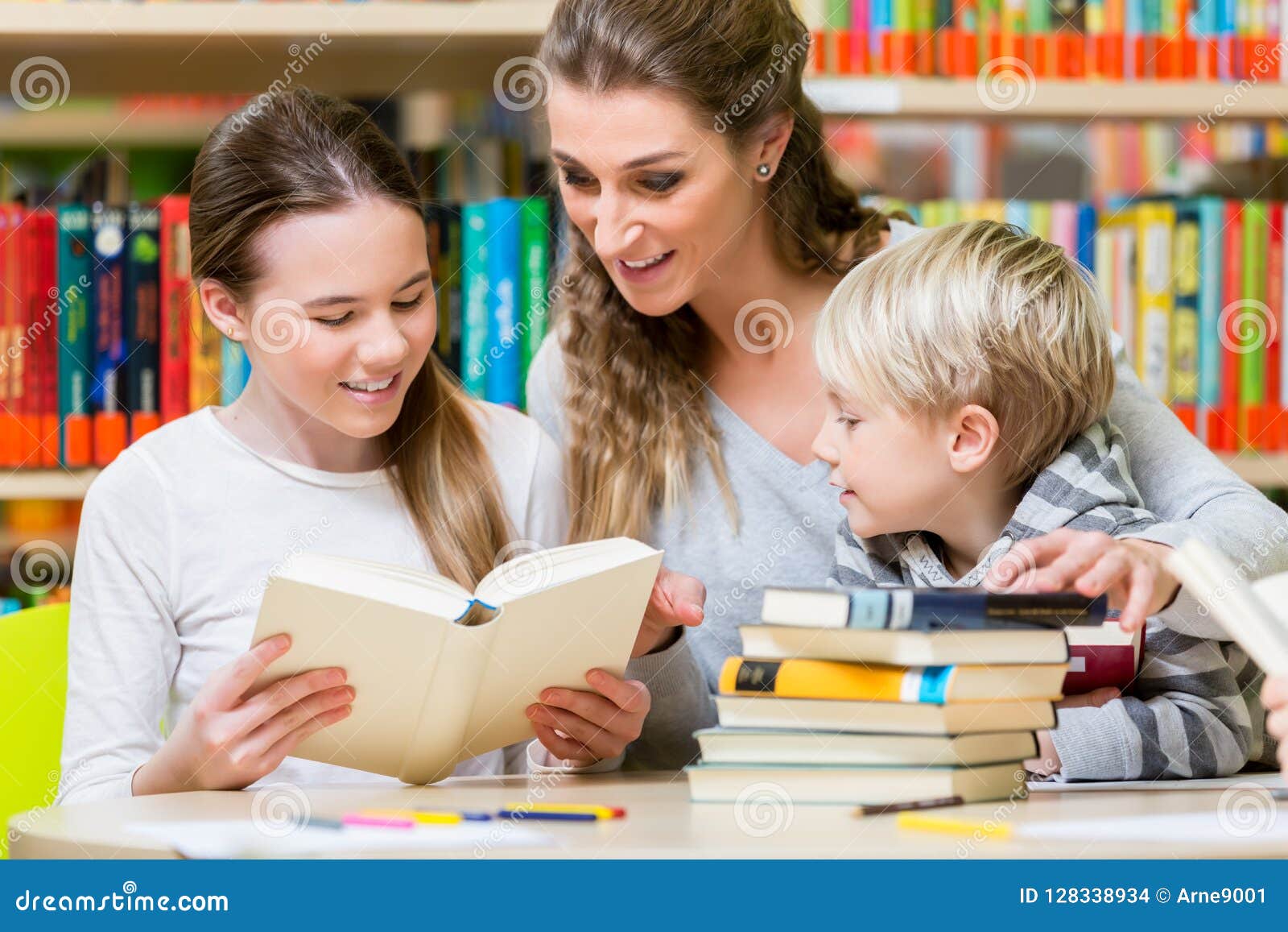 Teacher with Her Class Visiting the Library Reading Books Stock Photo ...