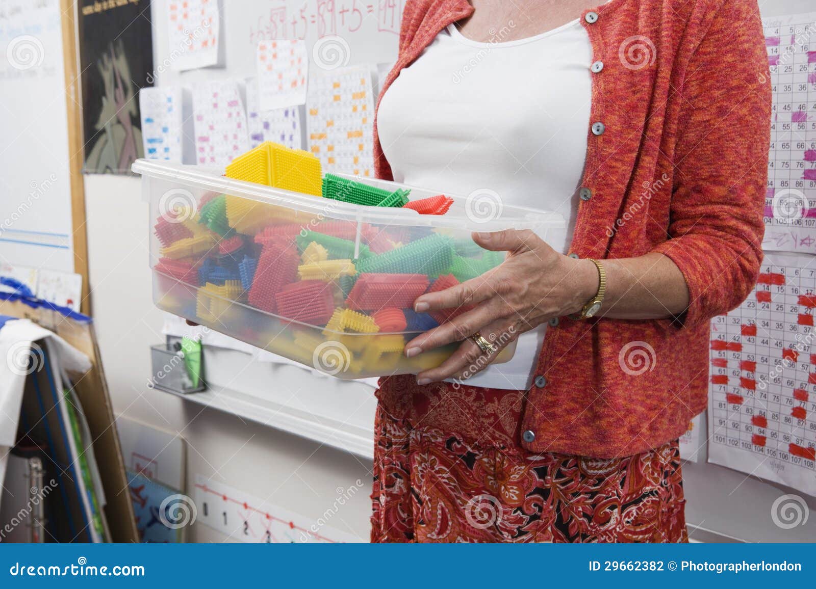Teacher Holding a Box Full of Plastic Puzzle Pieces Stock Photo - Image ...