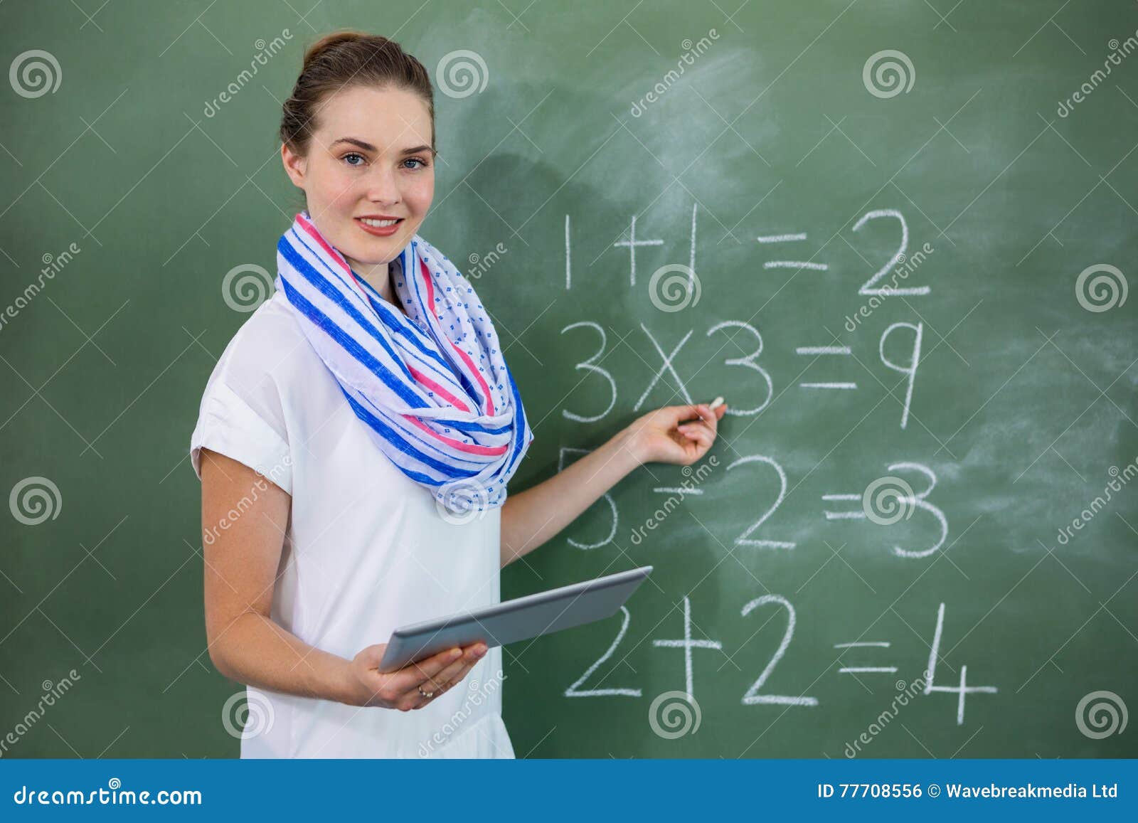 Teacher Holding Digiral Tablet while Teaching Mathematics in Classroom ...