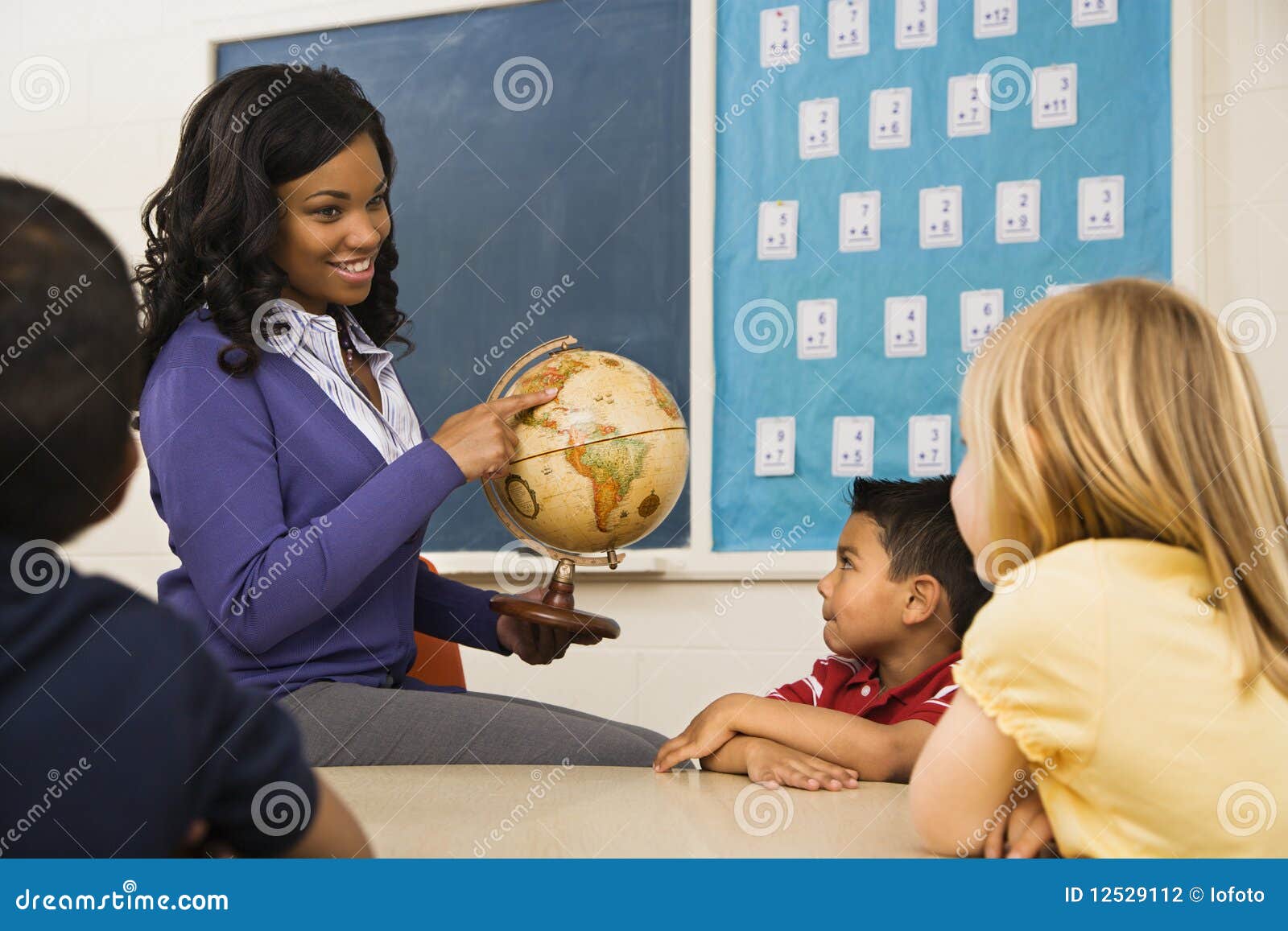 Teacher Holding Globe stock photo. Image of classroom - 12529112