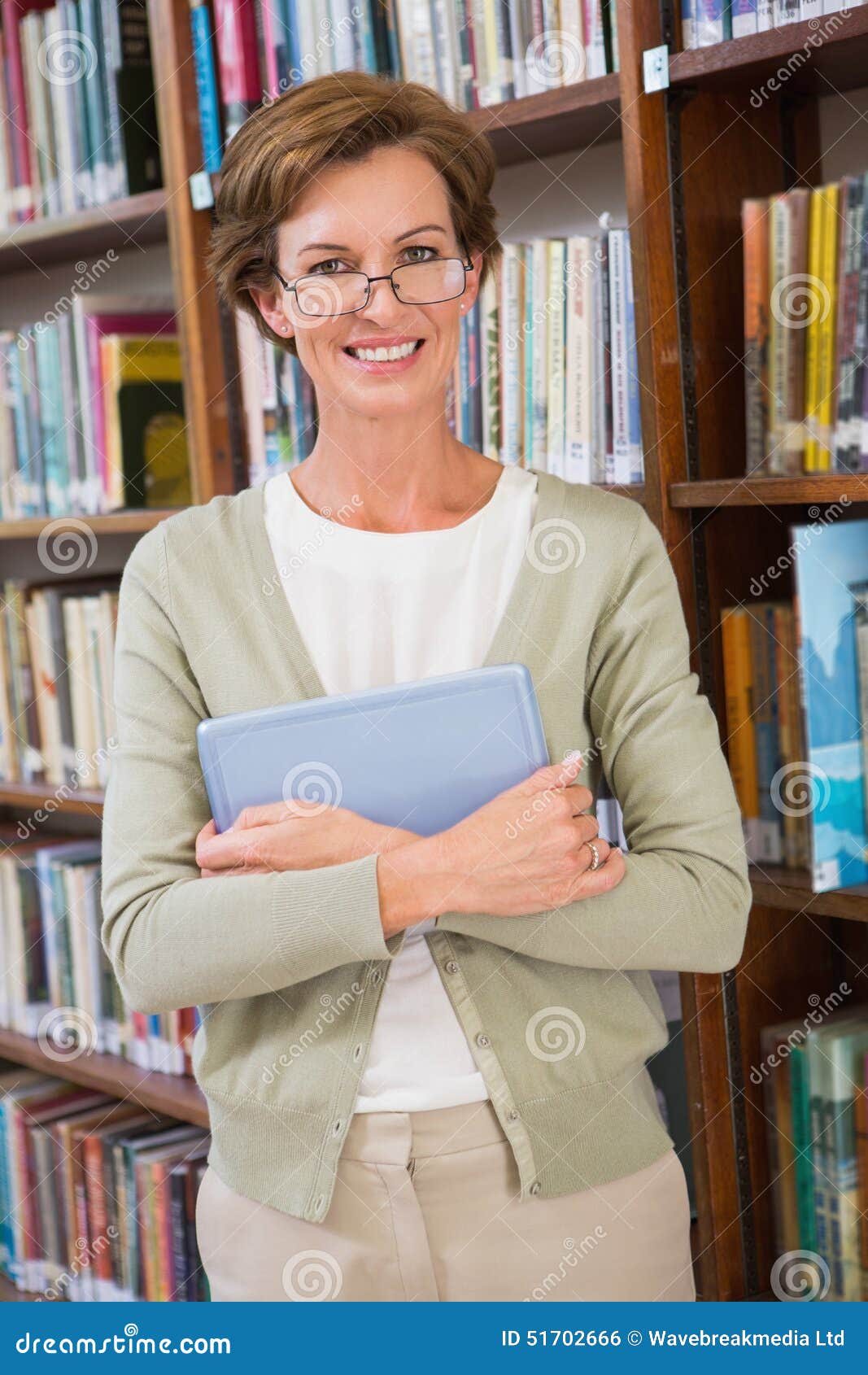 Teacher Holding Tablet Pc at Library Stock Photo - Image of smiling ...
