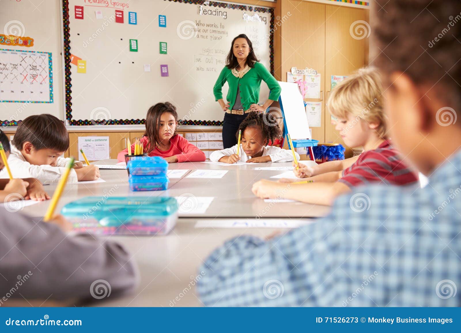 Teacher Instructing Elementary School Kids in Classroom Stock Image ...