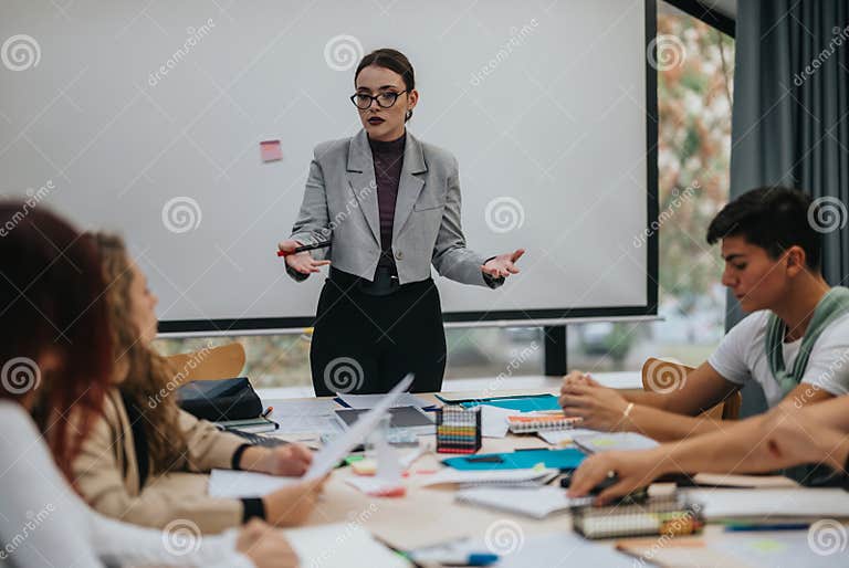 Teacher Instructing Students in Classroom Group Activity Stock Photo ...