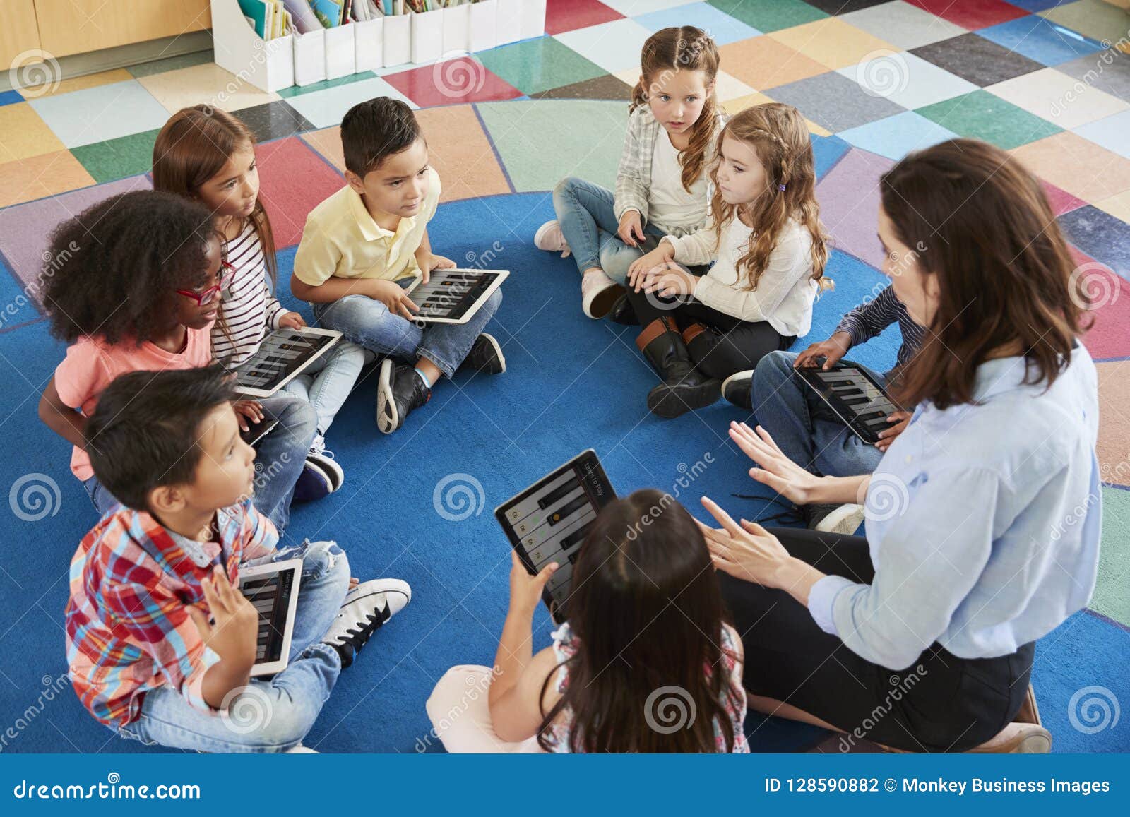 Teacher And Kids In An Elementary School Lesson With Tablets Royalty ...