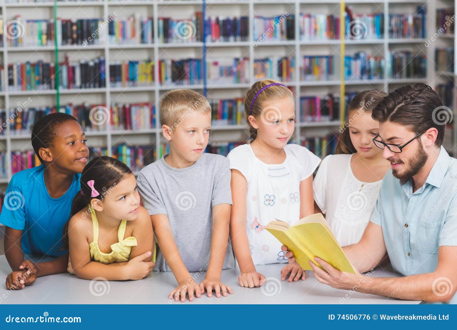 Teacher and Kids Reading Book in Library Stock Photo - Image of ...
