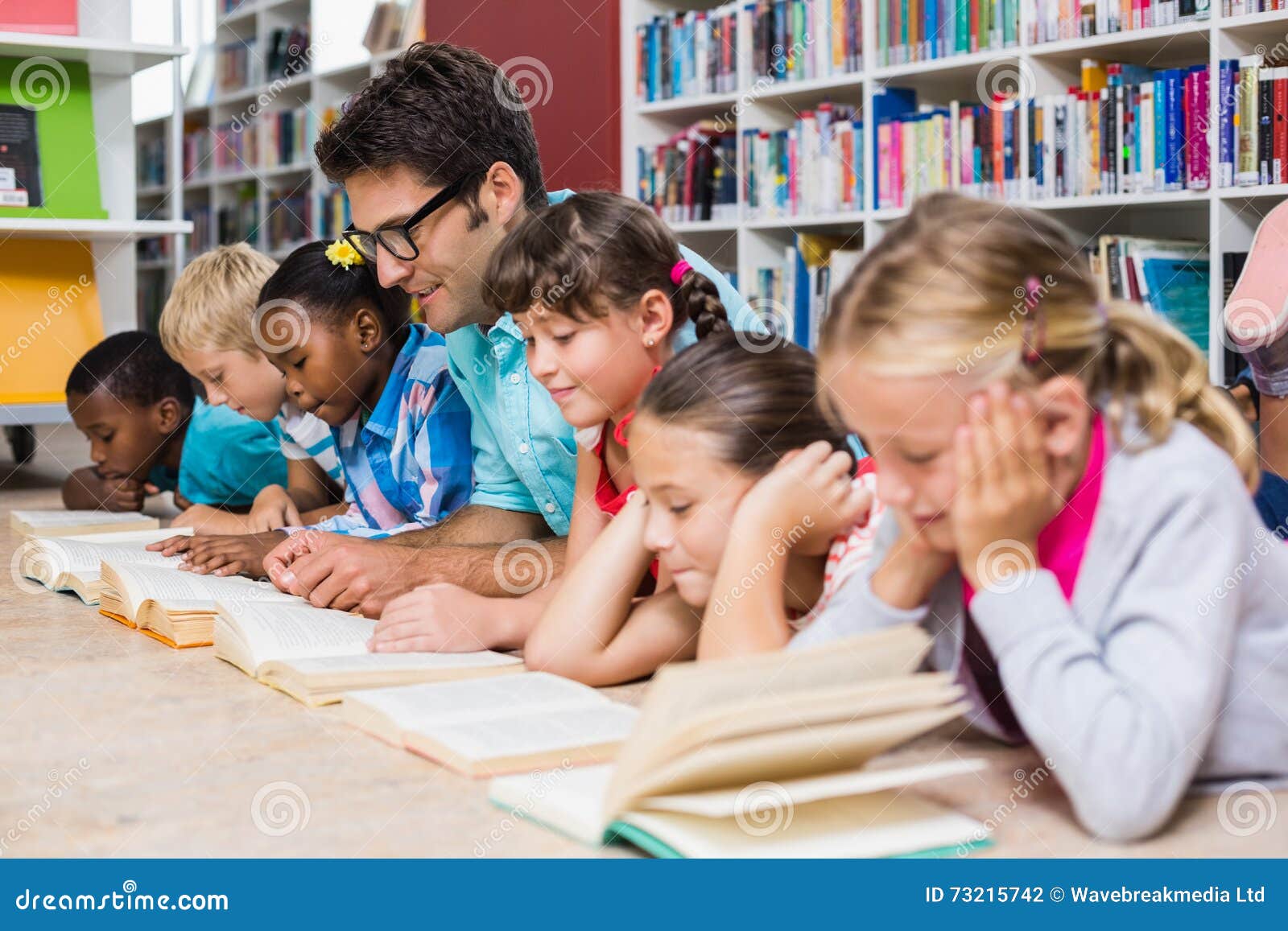 Teacher and Kids Reading Book in Library Stock Photo - Image of ...