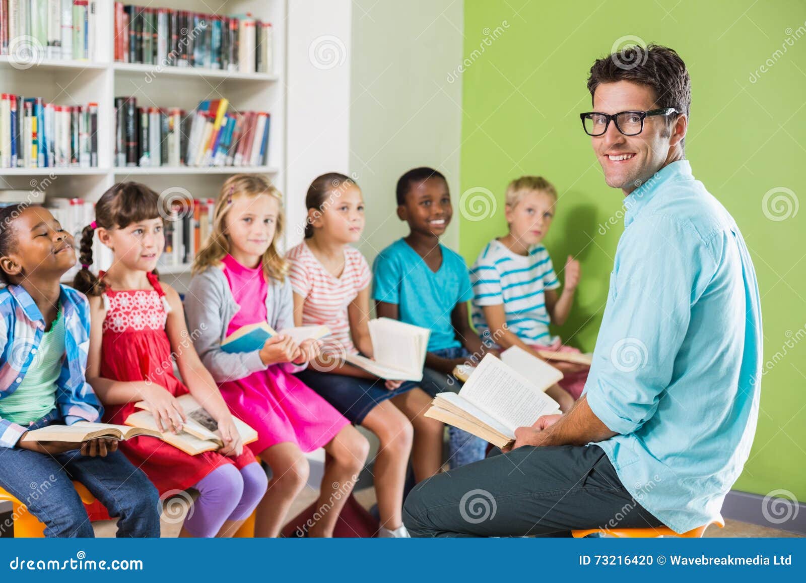 Teacher and Kids Reading Book in Library Stock Photo - Image of ...