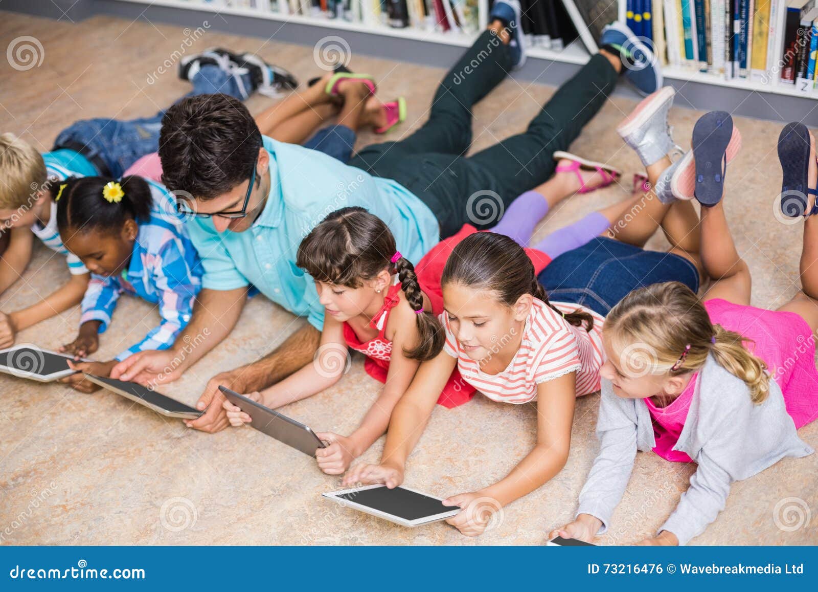 Teacher and Kids Using Digital Tablet in Library Stock Photo - Image of ...