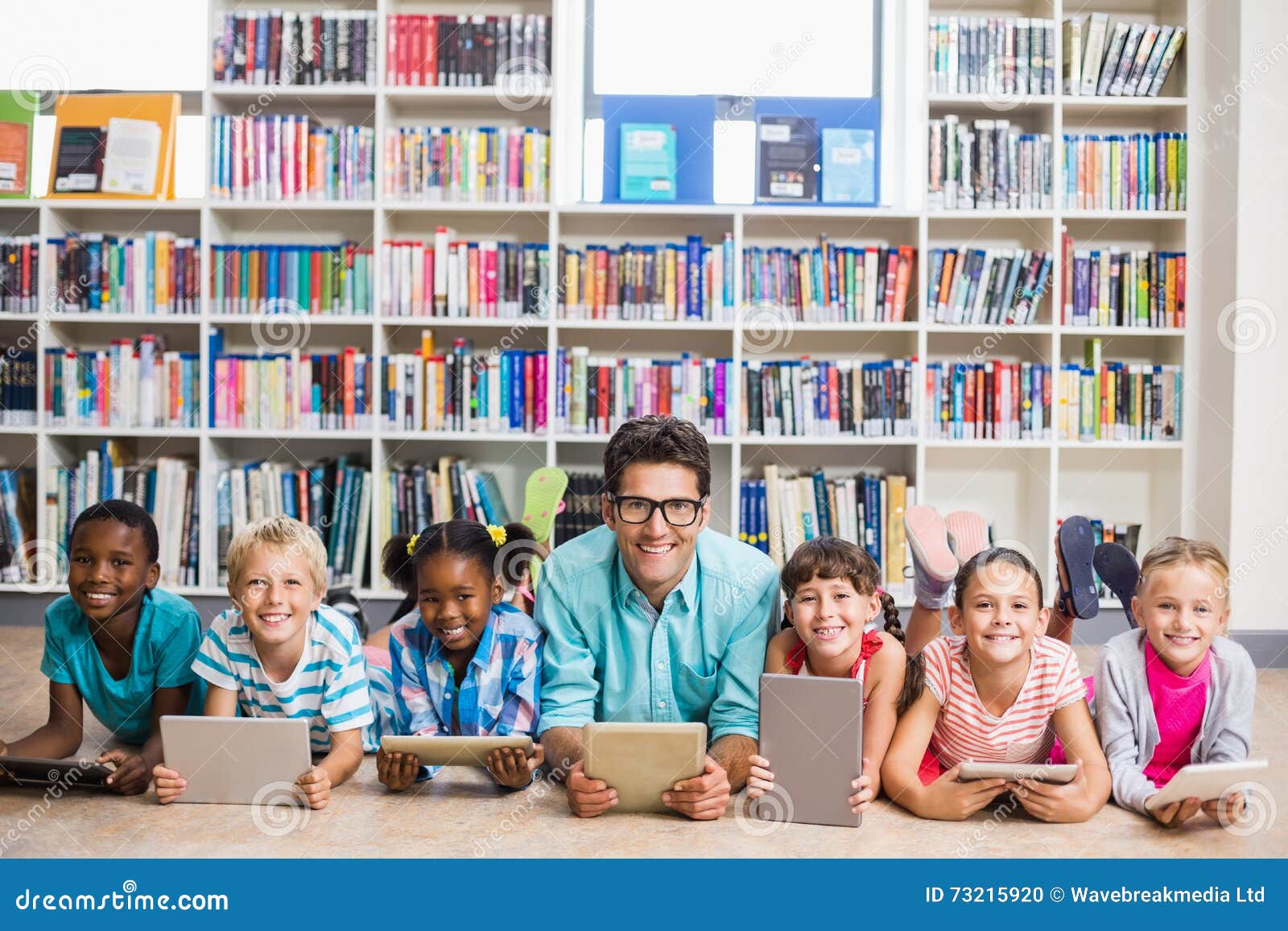 Teacher and Kids Using Digital Tablet in Library Stock Photo - Image of ...