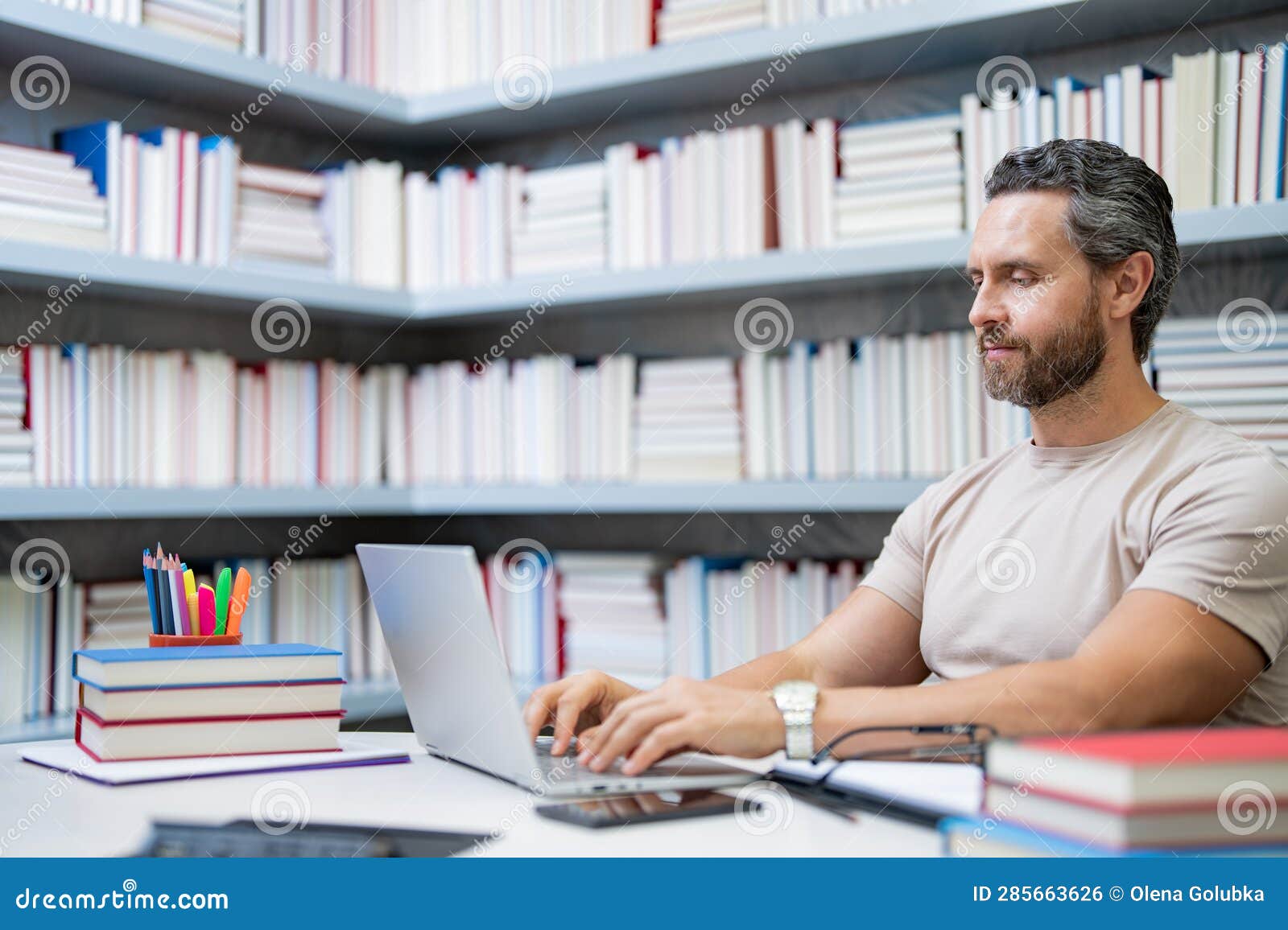 Teacher with Laptop in Library Classroom. Handsome Teacher Work on ...