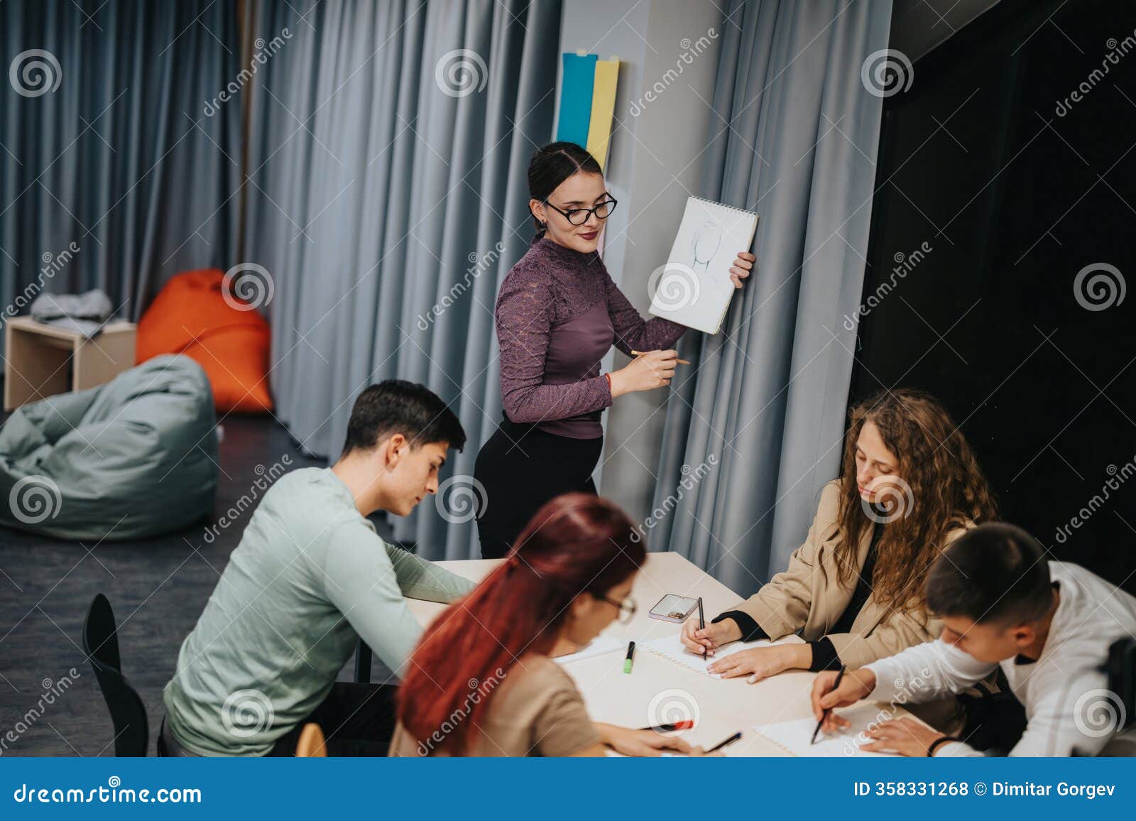 Teacher Guiding Students during an Interactive Classroom Session Stock ...