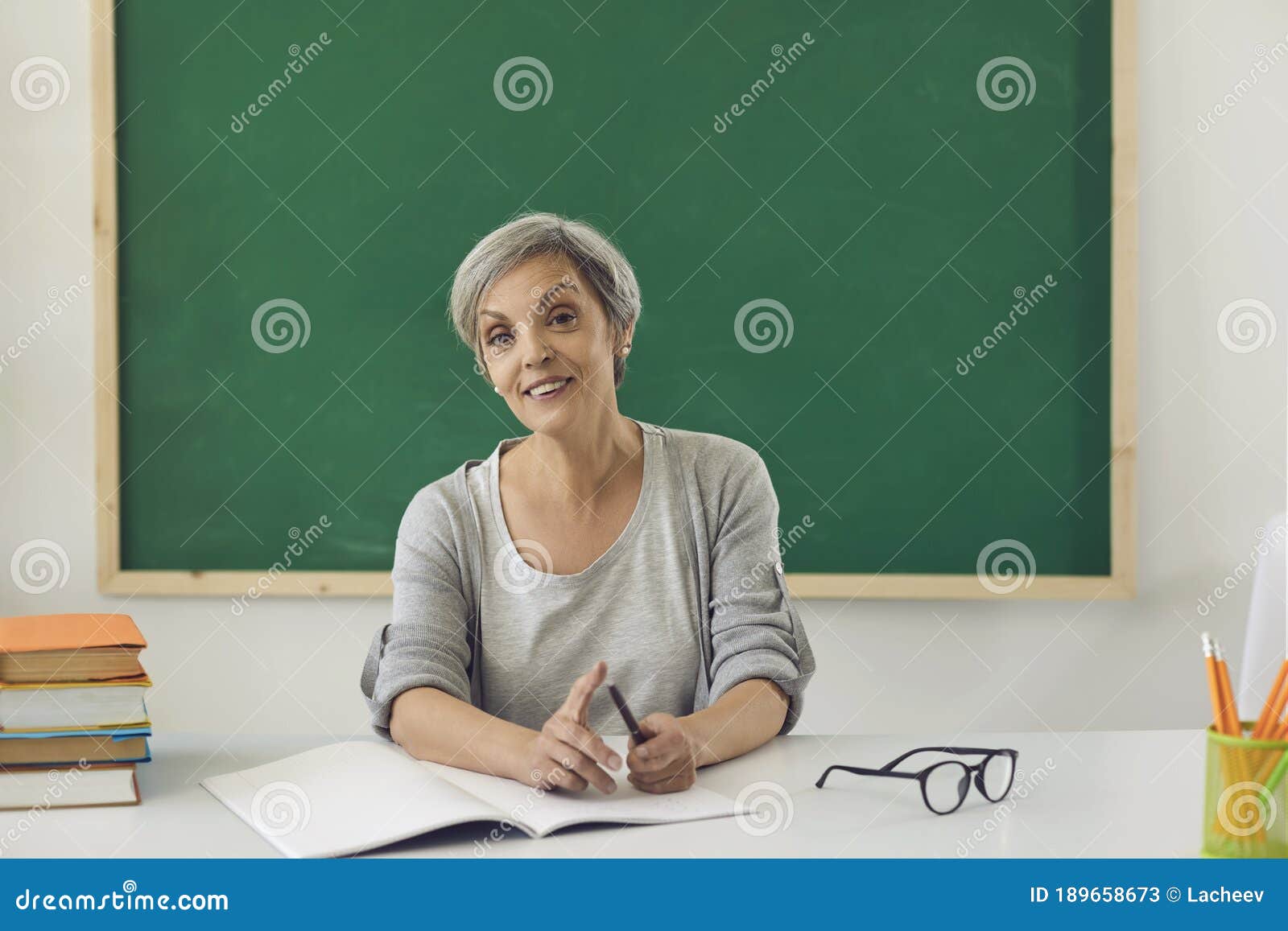 The Teacher is Looking at the Camera Online. Female Senior Teacher ...
