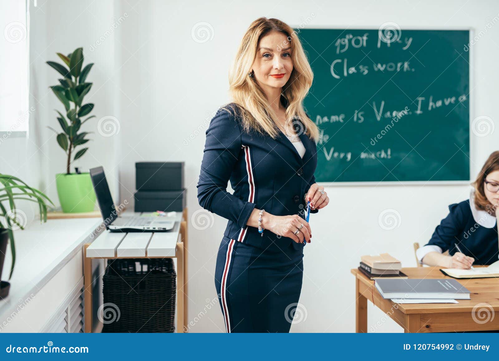 Teacher Looking at Camera Standing in Classroom Stock Photo - Image of ...