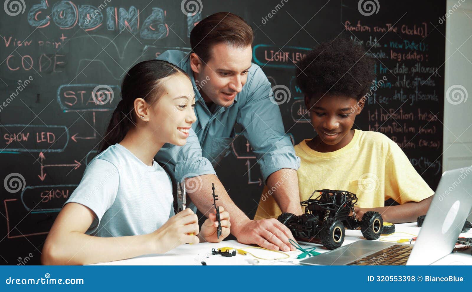 Teacher Looking at Laptop Screen while Explain Car Model System ...