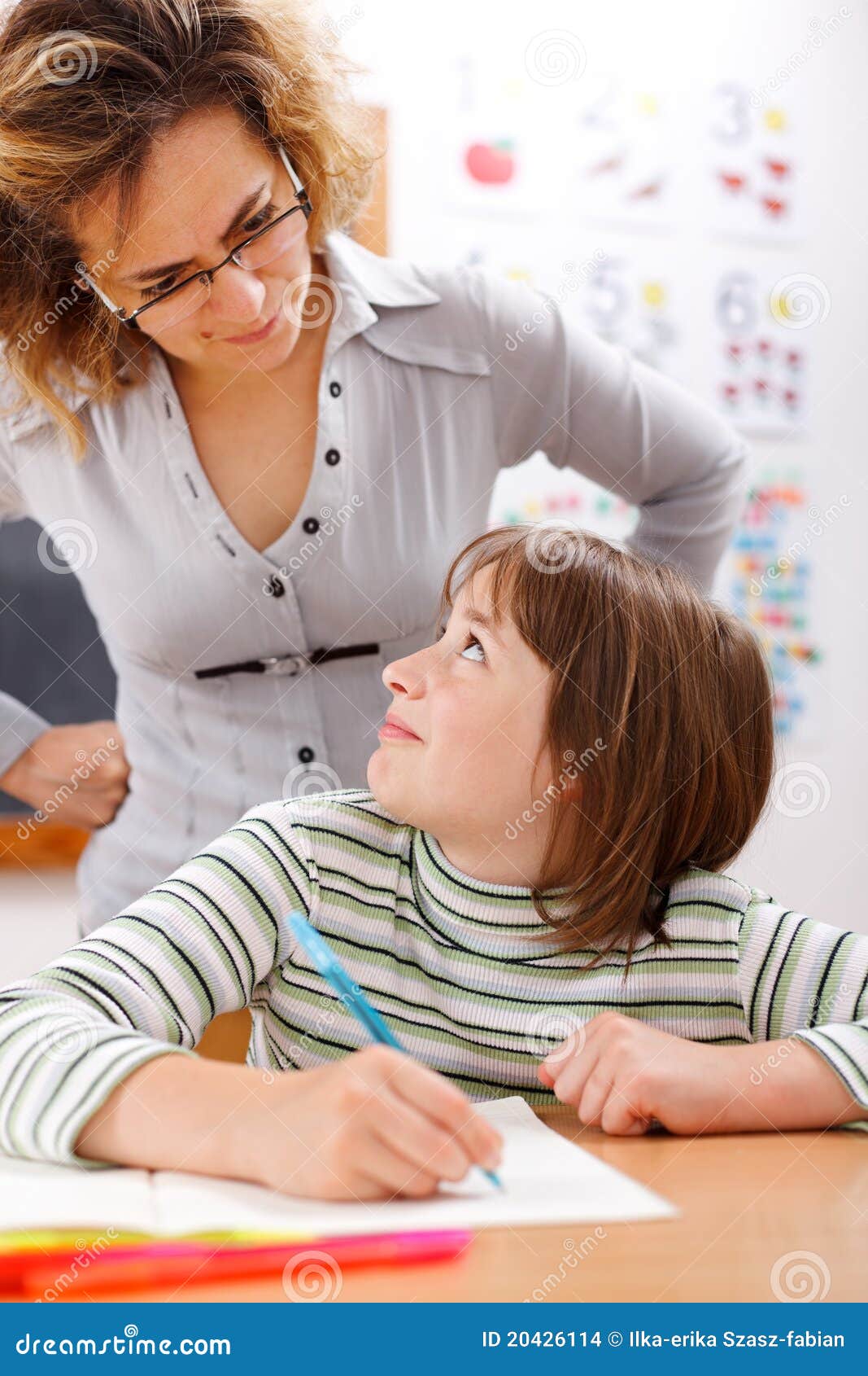 Teacher looking at student stock photo. Image of learner - 20426114