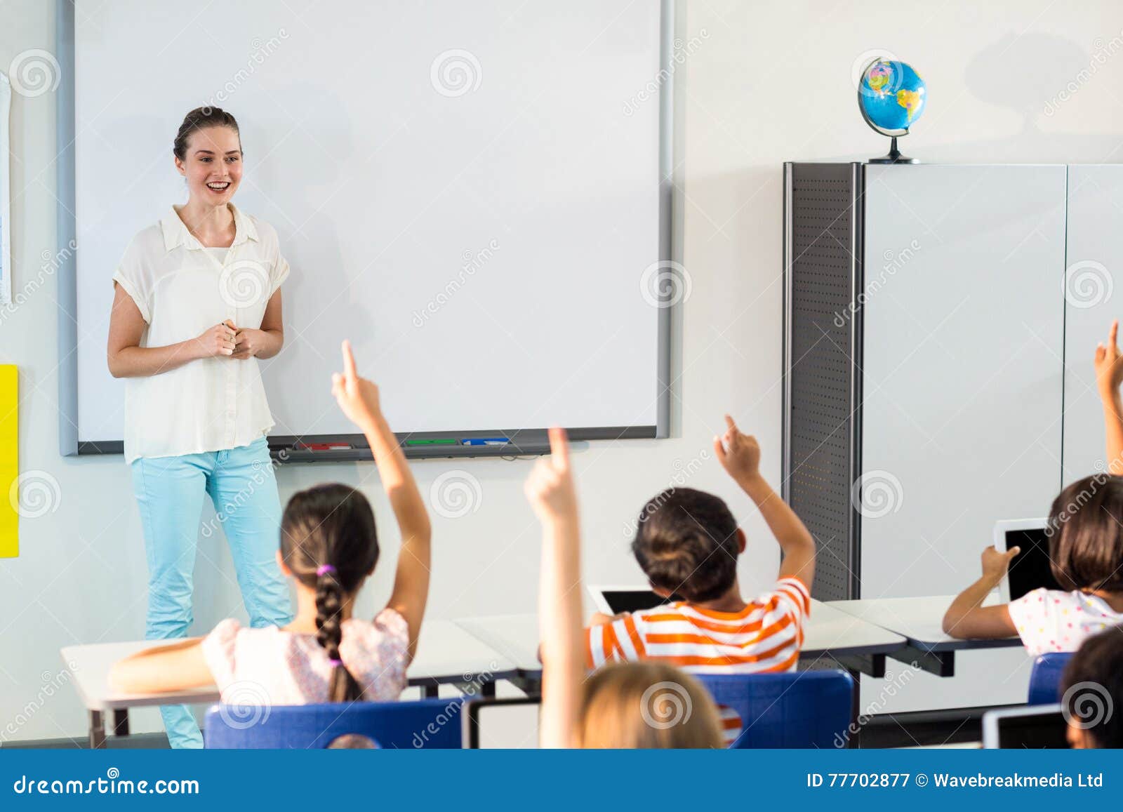 Teacher Looking at Students Raising Their Hands Stock Image - Image of ... Teacher Looking at Students Raising Their Hands Stock Image - Image of ...