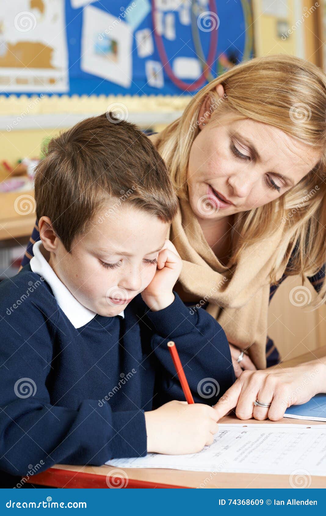Teacher with Male Elementary School Pupil with Problem Stock Image ...