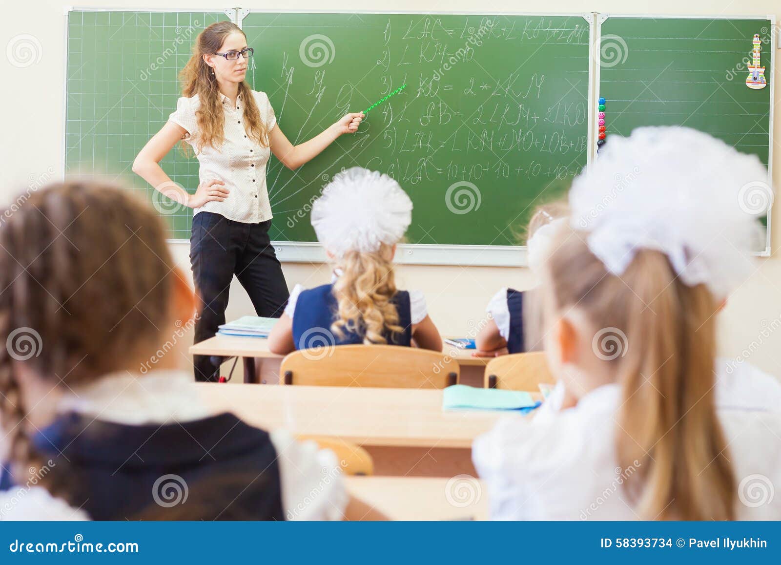 Teacher Near Blackboard Teaching Children Math or Geometry, Holding ...