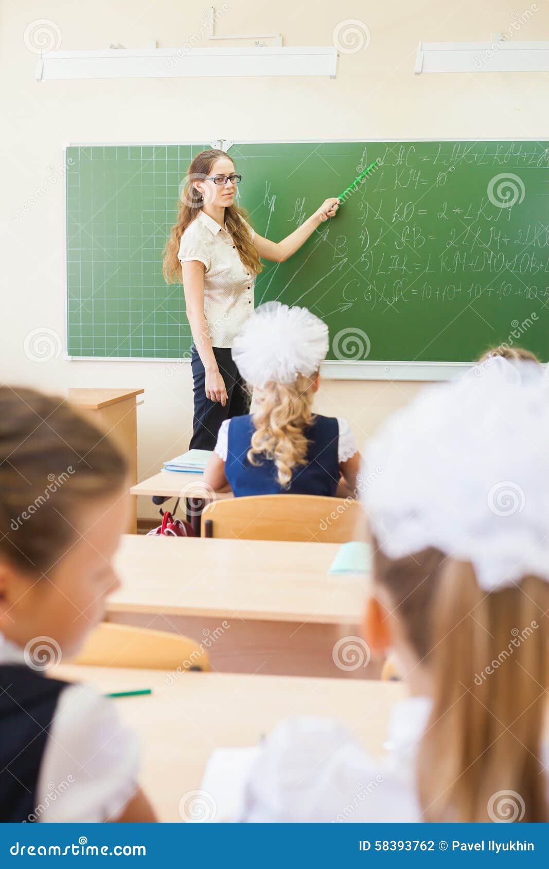 Teacher Near Blackboard Teaching Children Math or Geometry, Holding ...